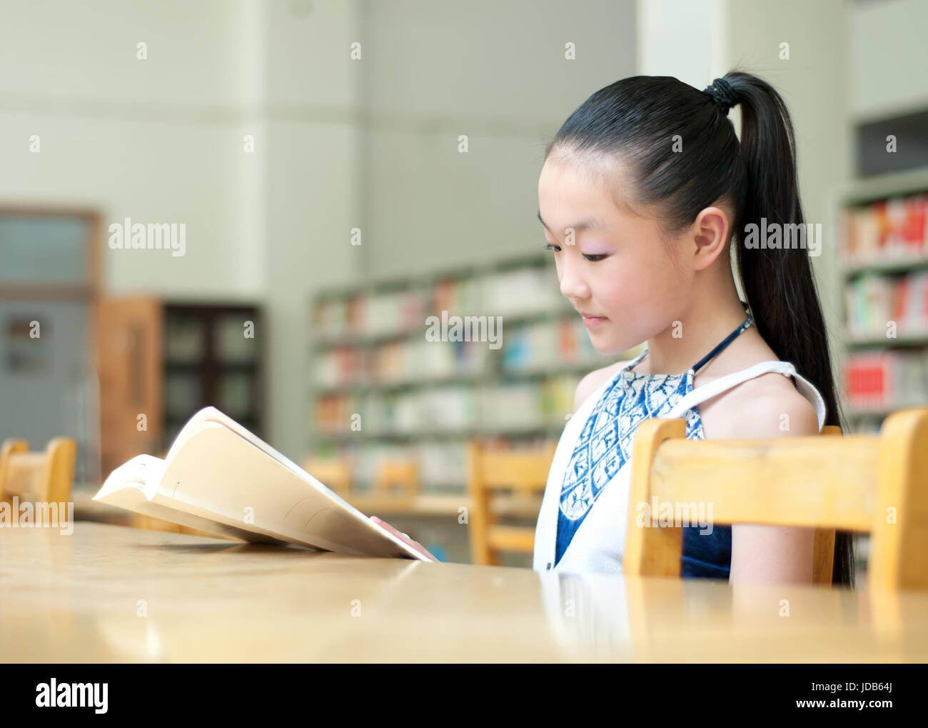 Pretty girls reading in the library, very serious study Stock Photo - Alamy
