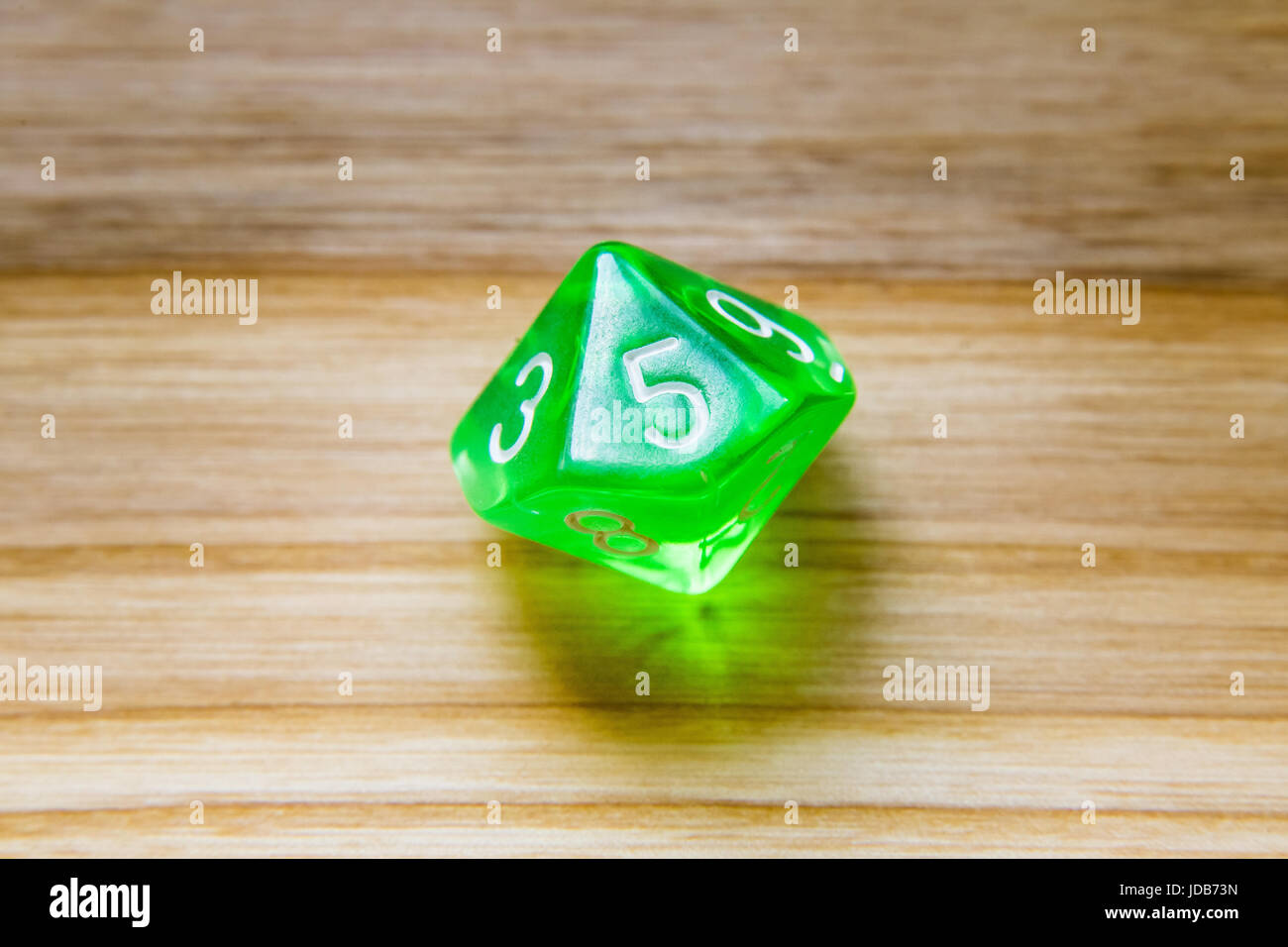 A beautiful winning playing dice rolled on a side on wooden table Stock ...