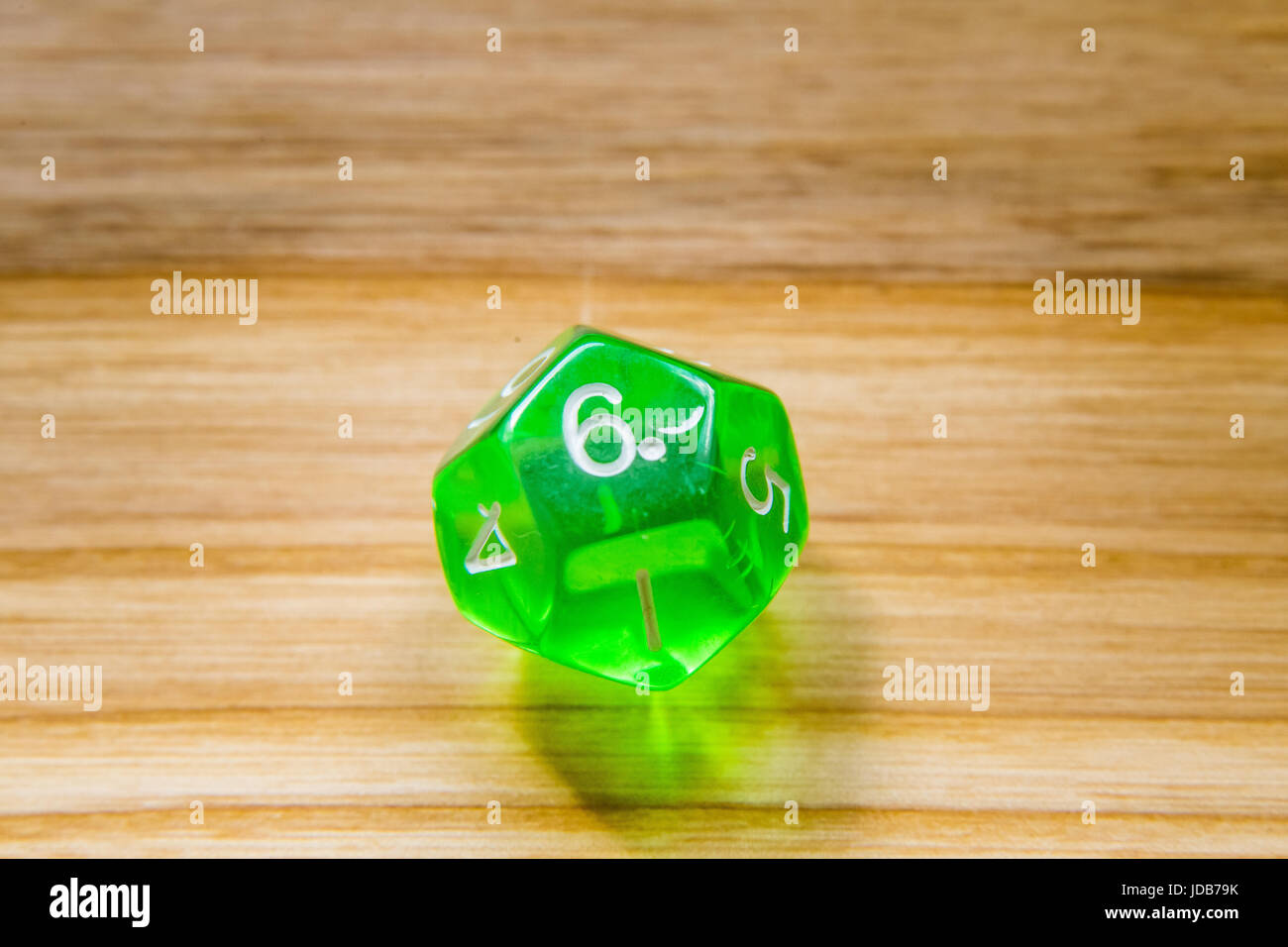 A beautiful winning playing dice rolled on a side on wooden table Stock ...