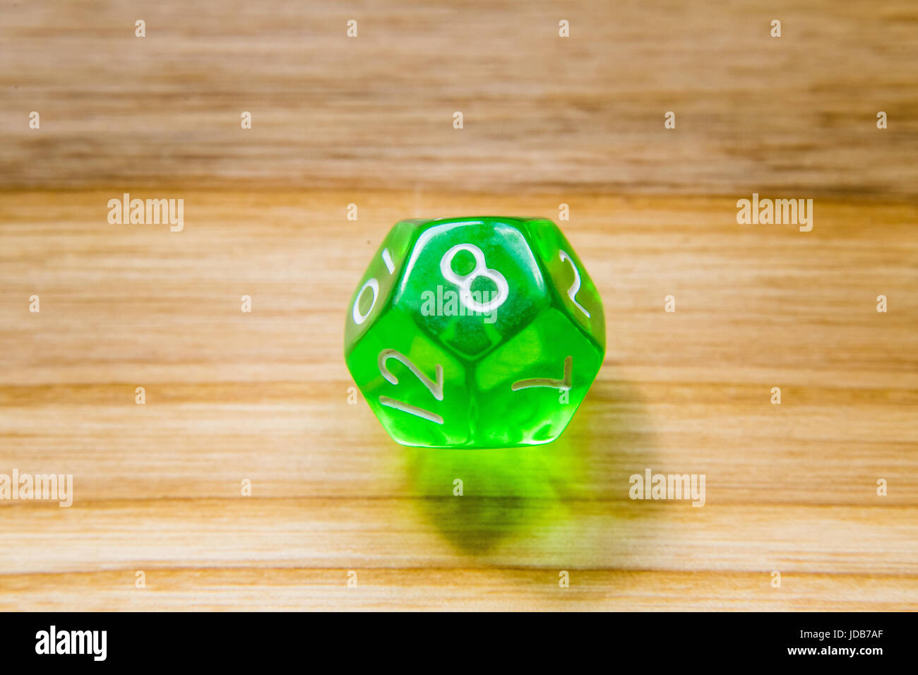 A beautiful winning playing dice rolled on a side on wooden table Stock ...