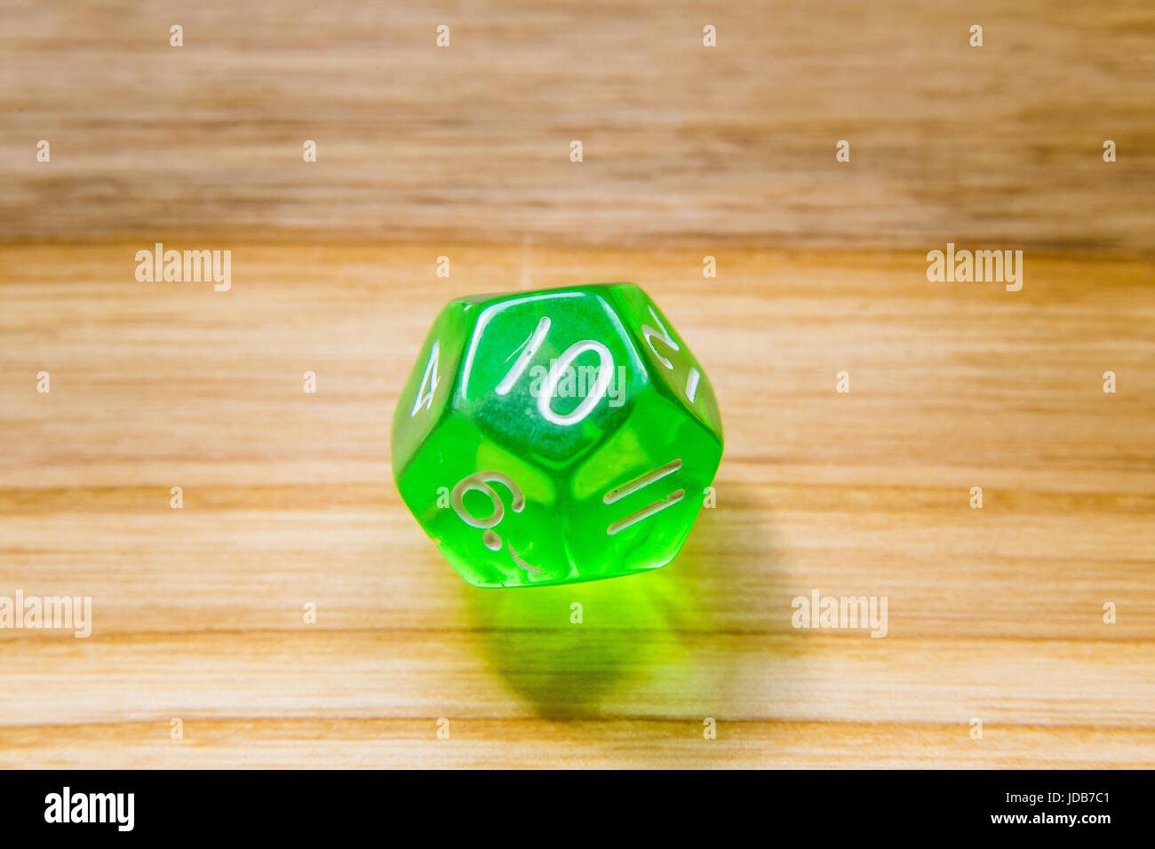 A beautiful winning playing dice rolled on a side on wooden table Stock ...
