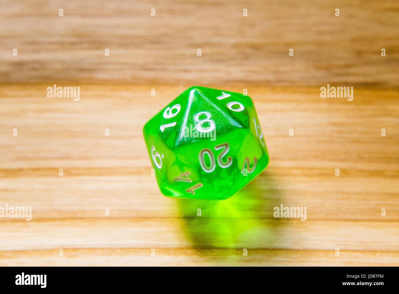A beautiful winning playing dice rolled on a side on wooden table Stock ...