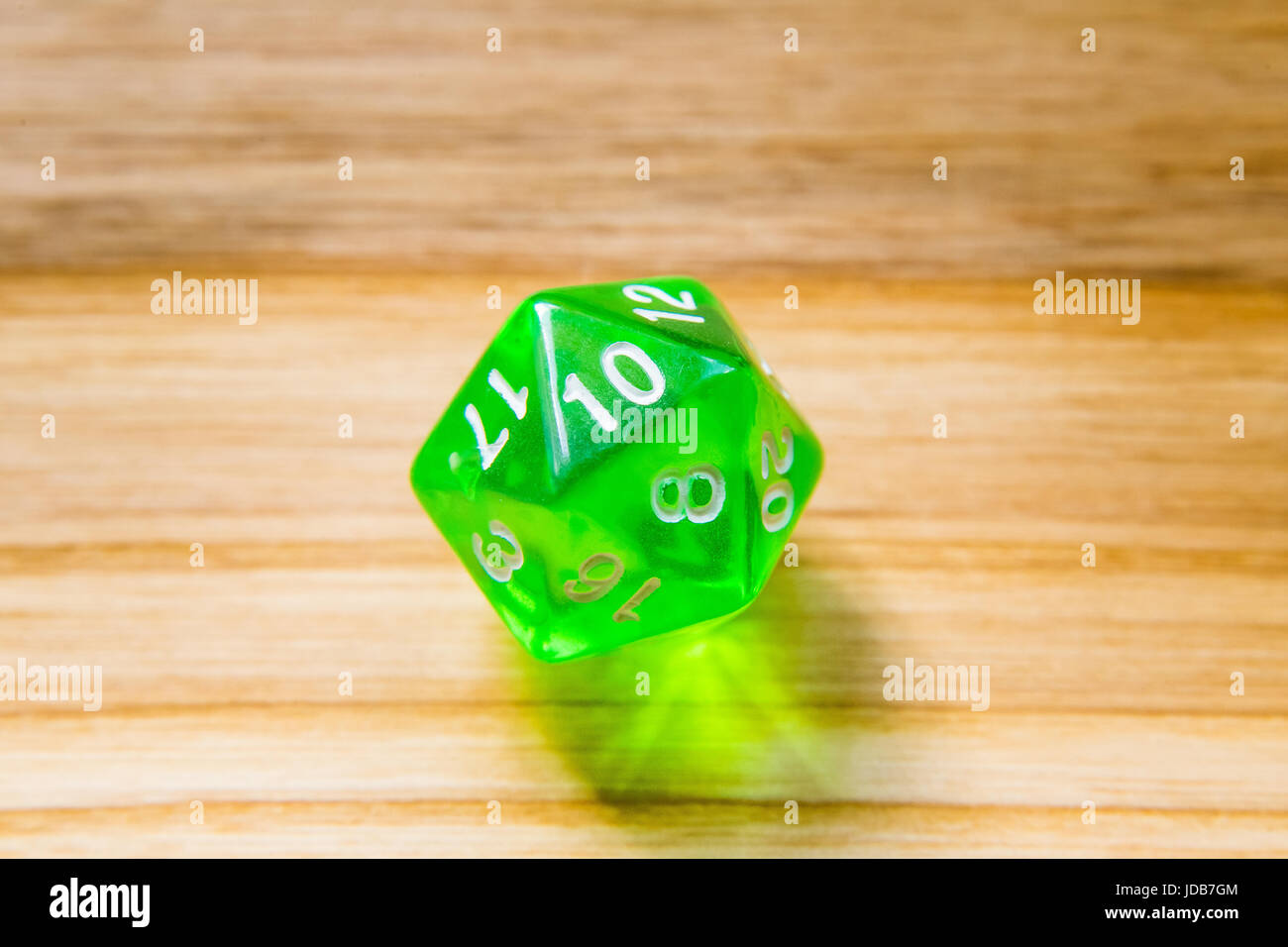 A beautiful winning playing dice rolled on a side on wooden table Stock ...