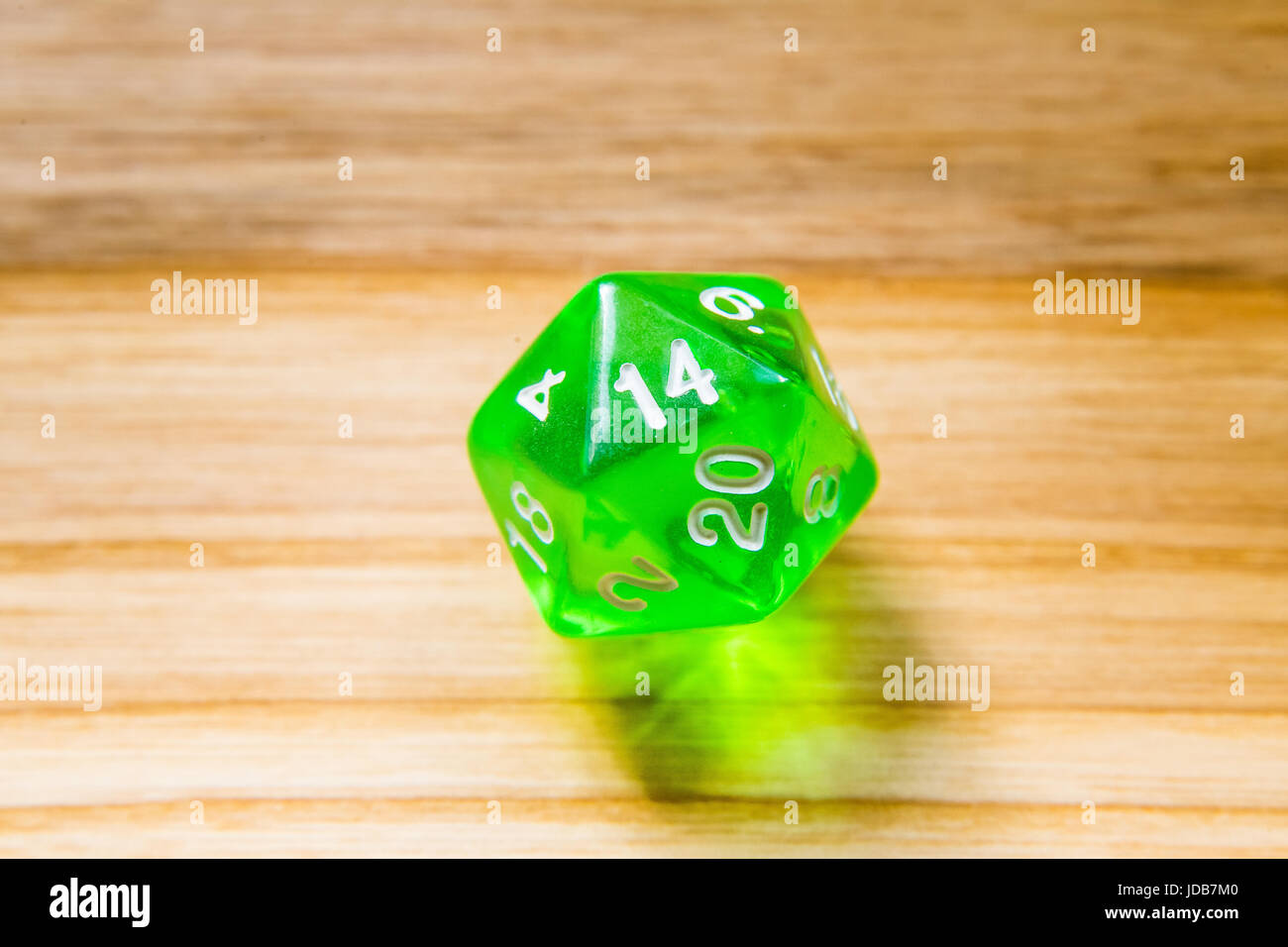 A beautiful winning playing dice rolled on a side on wooden table Stock ...