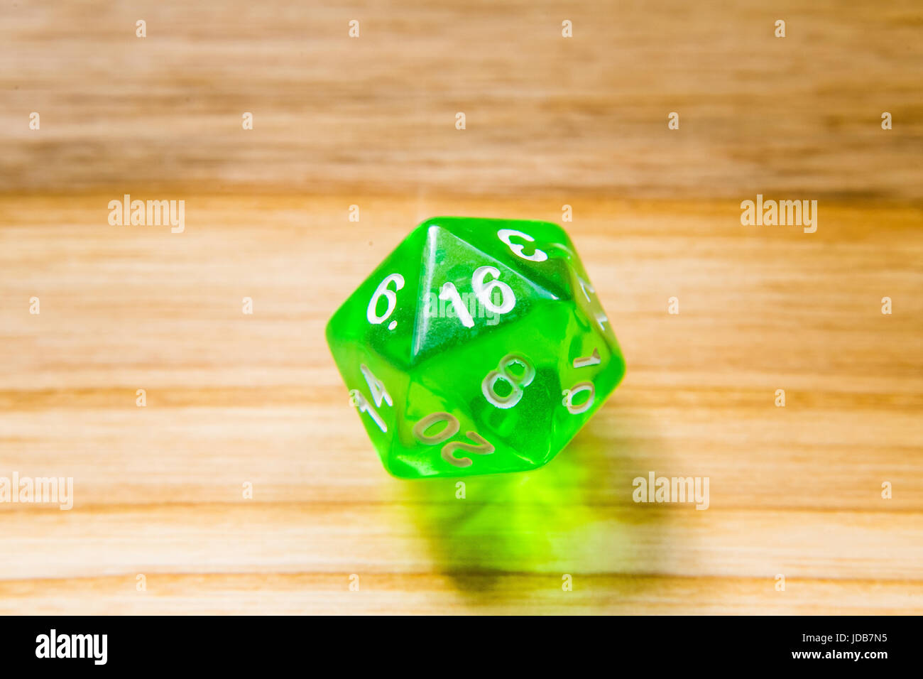A beautiful winning playing dice rolled on a side on wooden table Stock ...