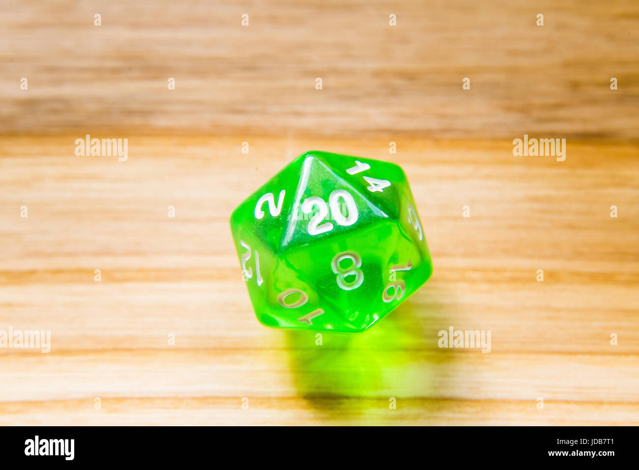 A beautiful winning playing dice rolled on a side on wooden table Stock ...