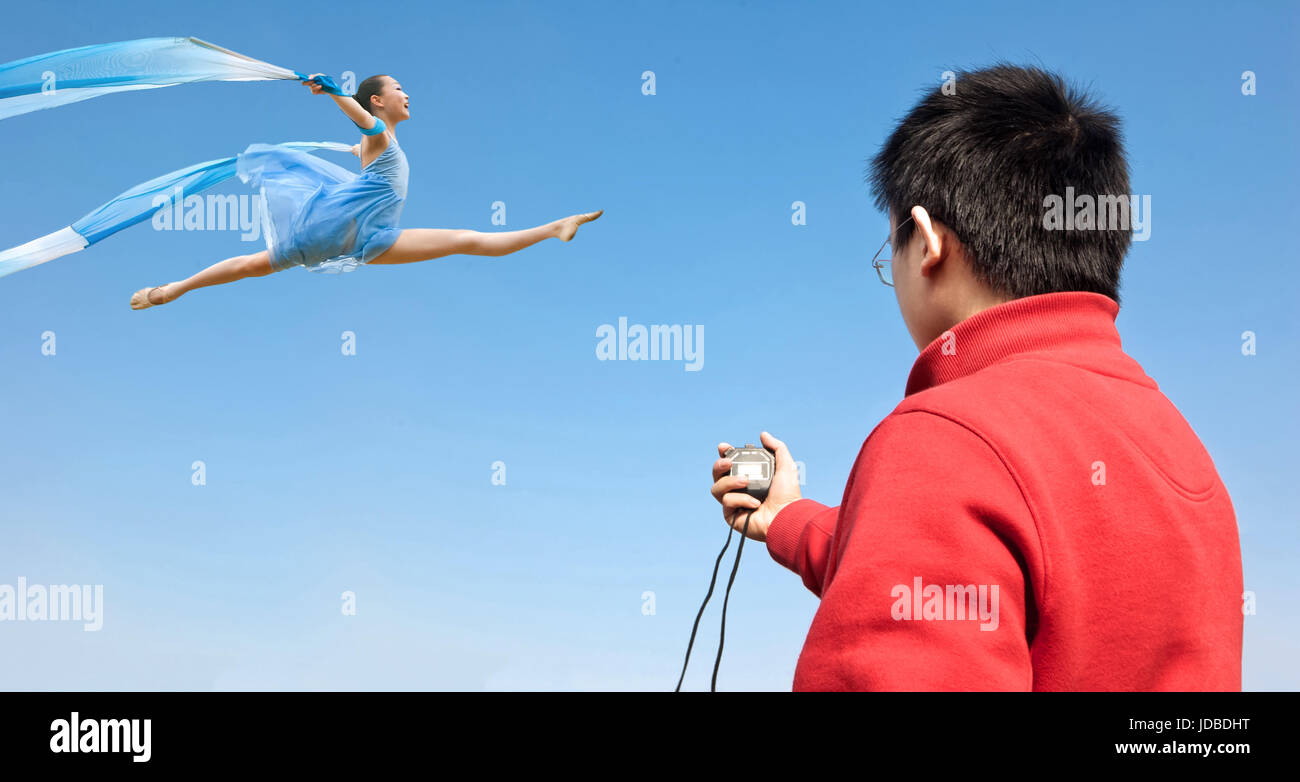 Under the blue sky, boy stopwatch operation Stock Photo - Alamy