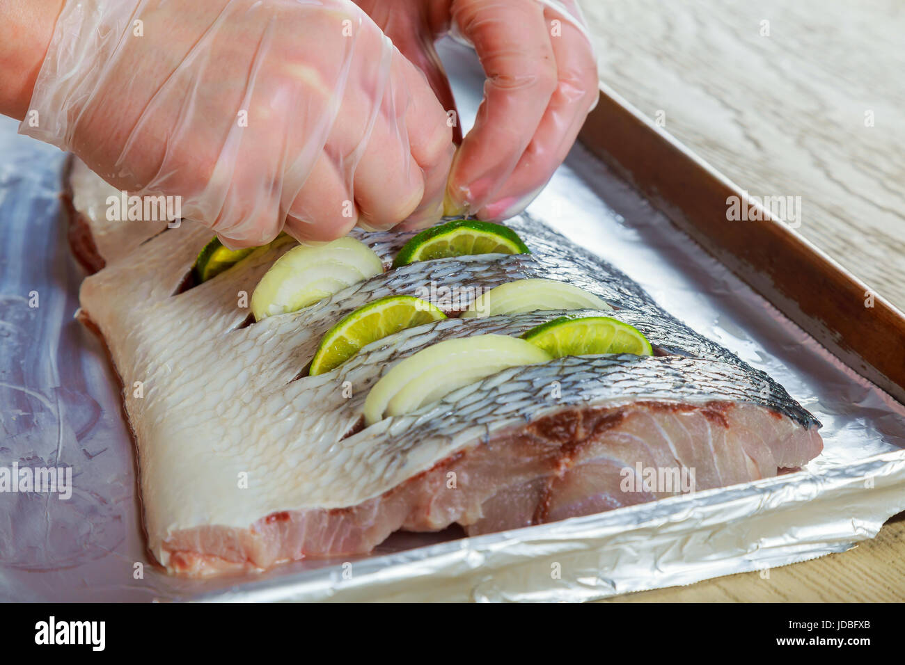 Marinated fried fish fry with spices n lemon filets in oil with lemon ...
