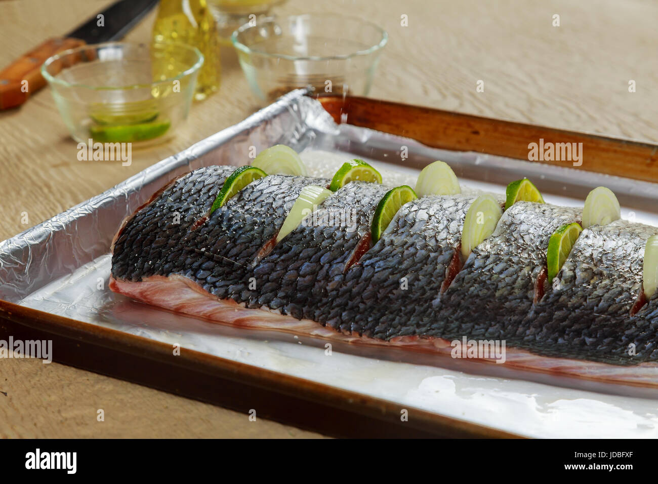 Delicious marinated fillet fish with lemon and onion dish in the oven ...