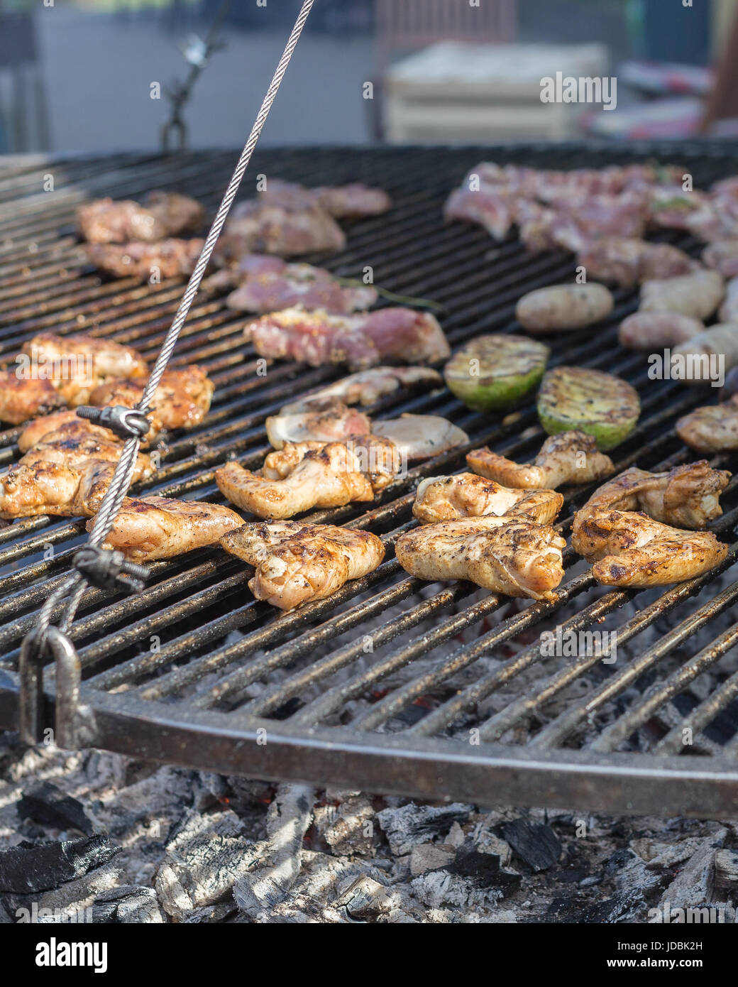 Cooking meat on the big flaming BBQ grill at street food market Stock ...