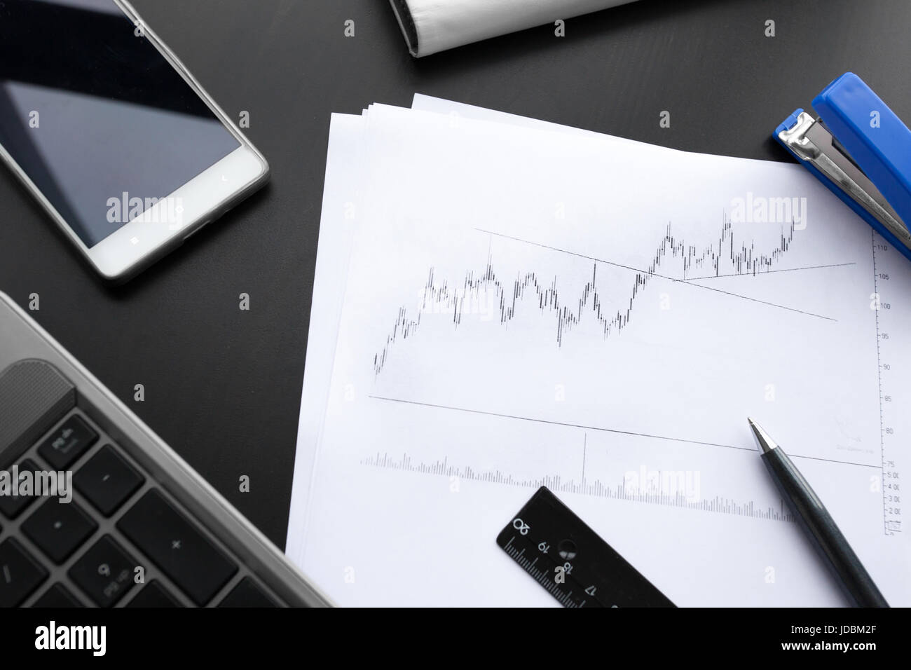 Pen showing diagram on financial report Stock Photo - Alamy