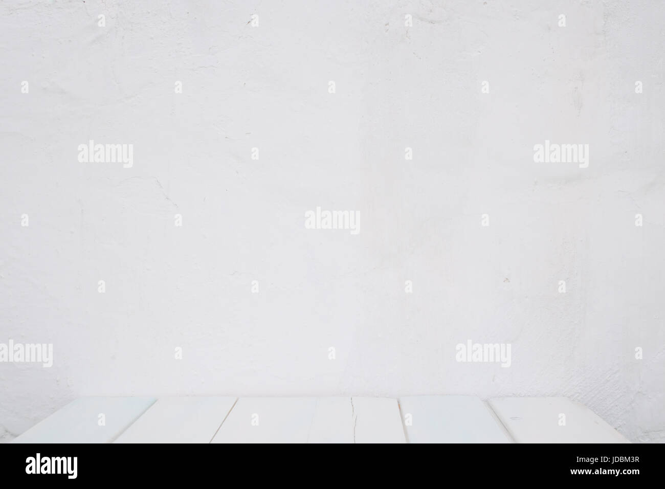 Empty white table on white blurred background wall Stock Photo - Alamy
