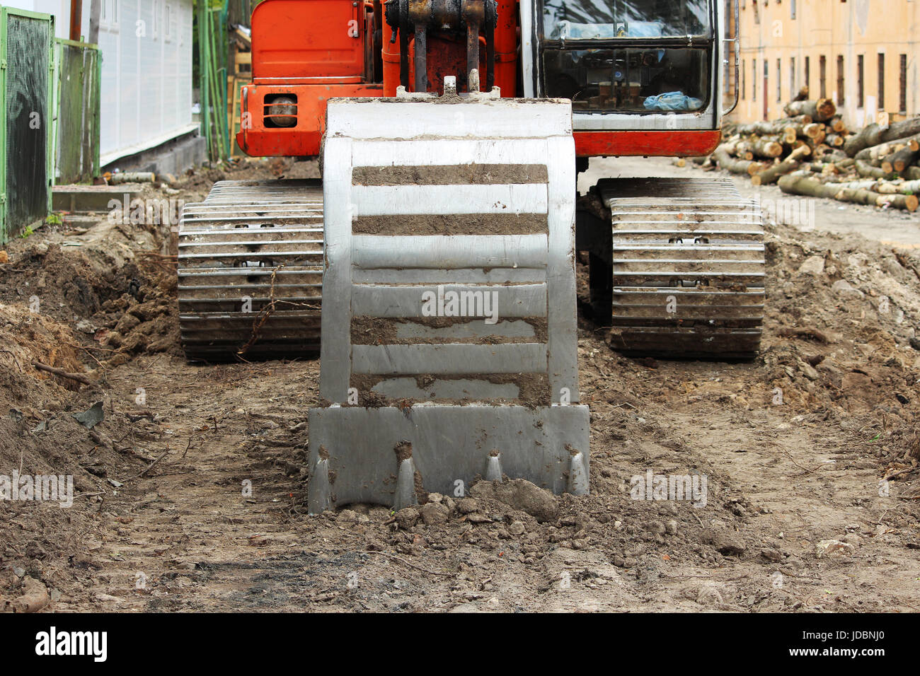 Bucket of an old excavator working on a parking lot on a day off Stock ...