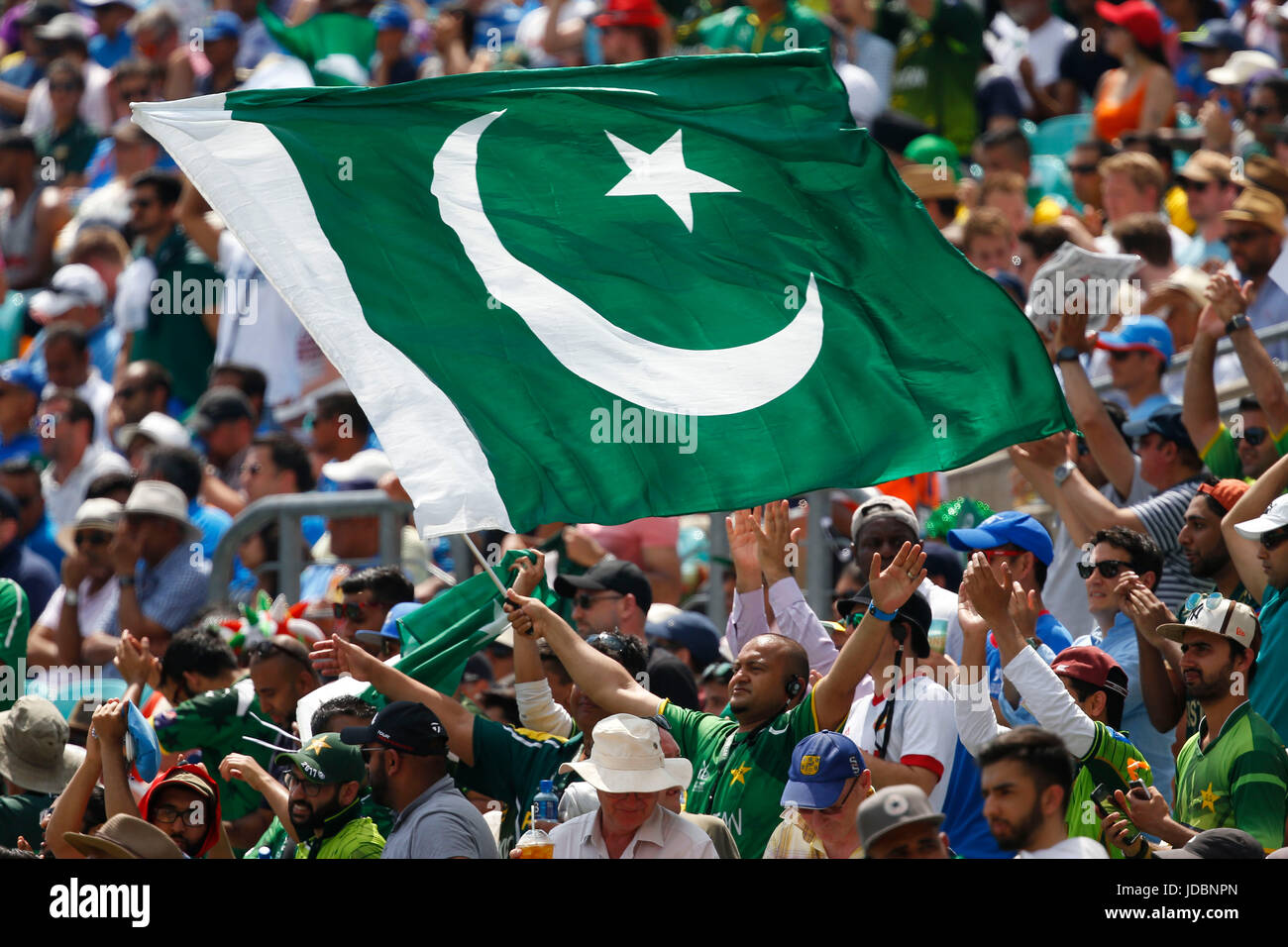 A Pakistan supporter waves a large flag from the stands at the Oval ...