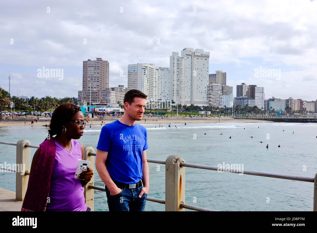 Durban South Africa. An ethnically diverse couple out walking along the pier on the beachfront ...