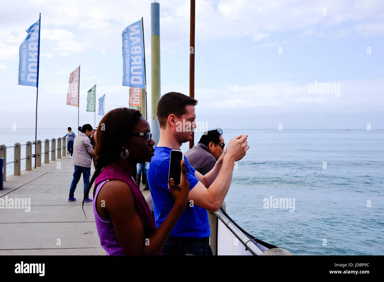 Durban South Africa. An ethnically diverse couple out walking along the pier on the beachfront ...