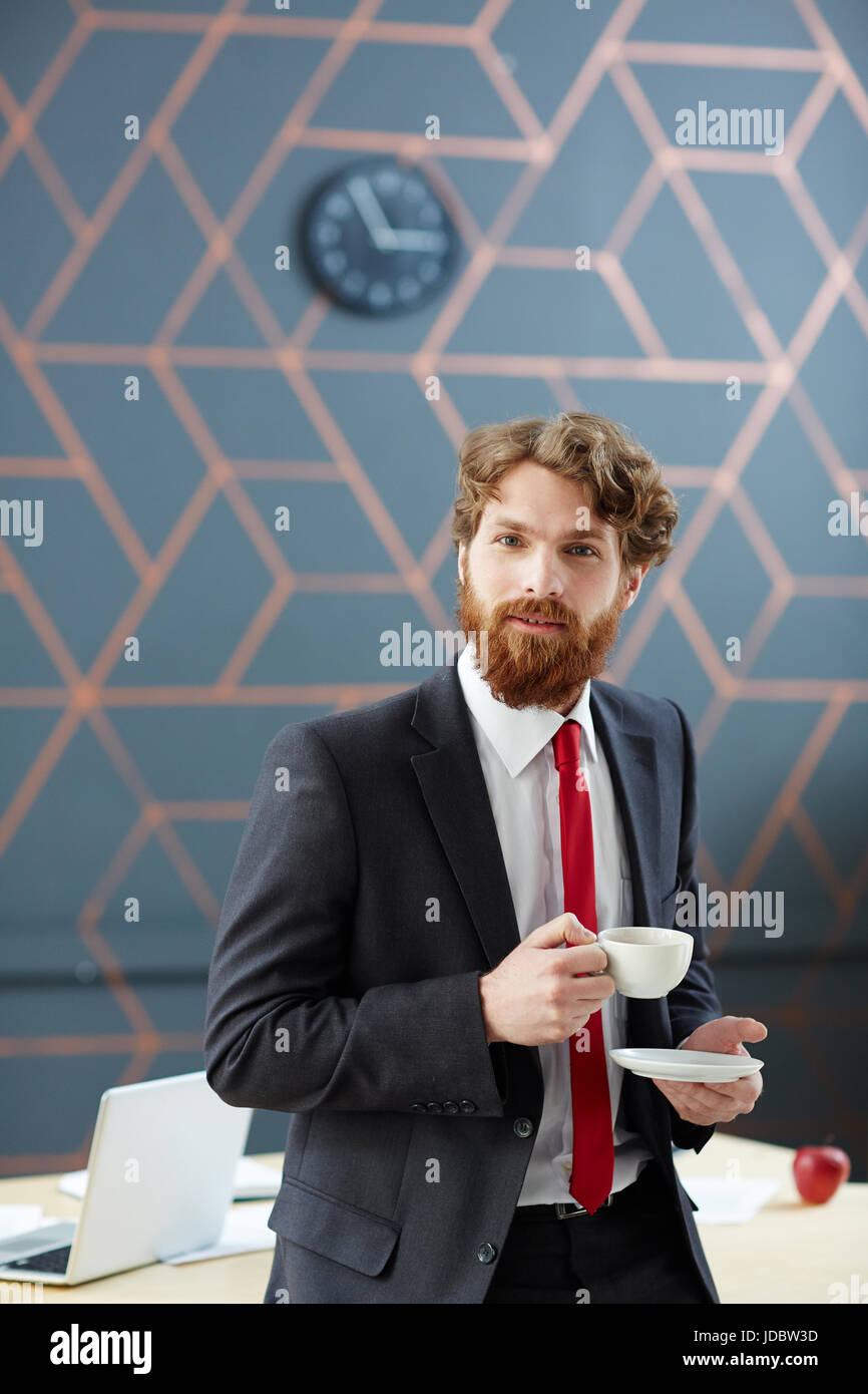 Caucasian business leader with cup of tea Stock Photo - Alamy