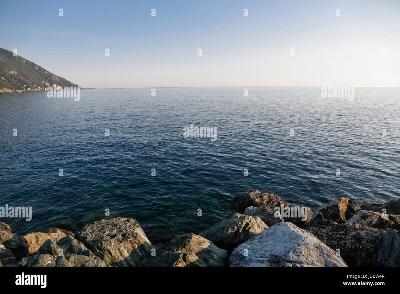 Mediterranean sea coastline with blue sky and rocks, Liguria, Italy ...