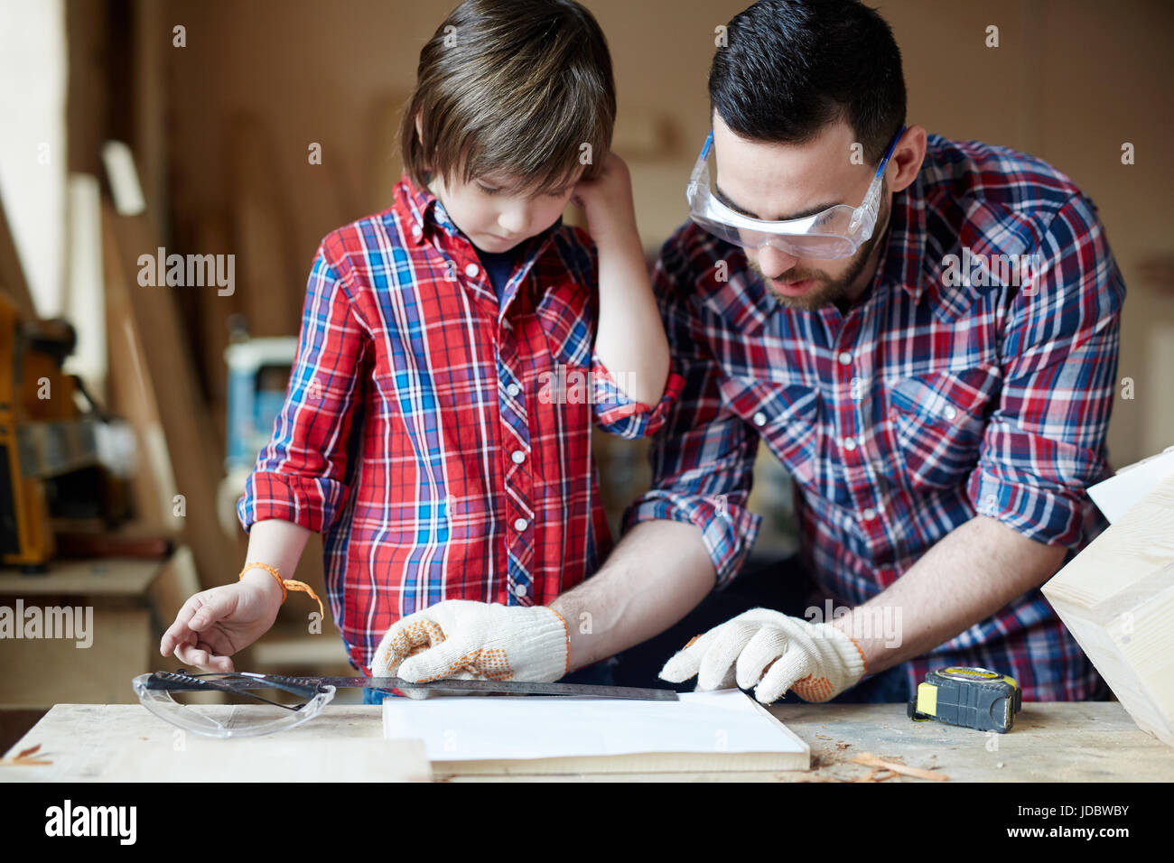 Creative man teaching his son to make things from wood Stock Photo - Alamy