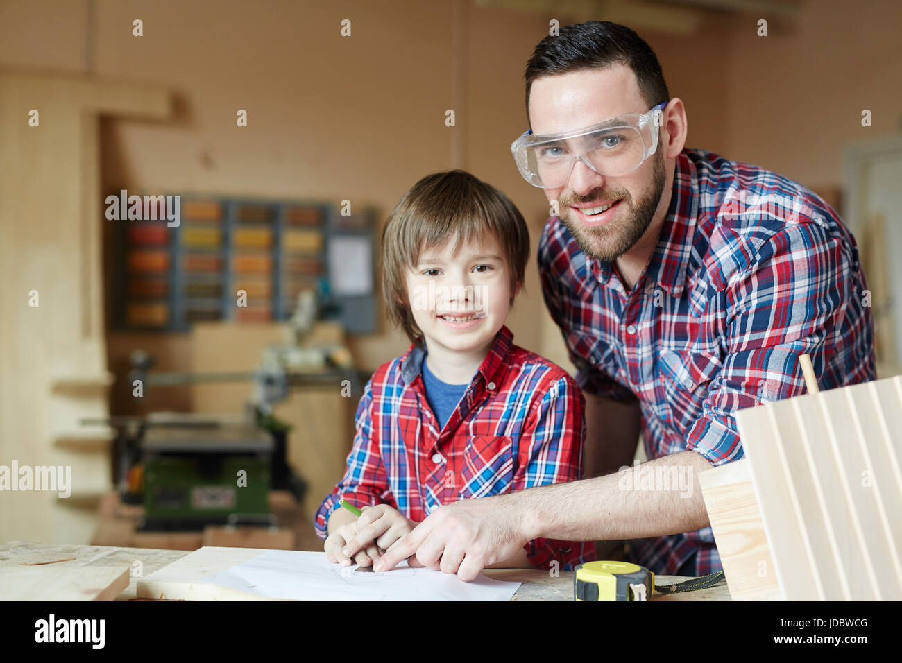 Creative boy and his father drawing sketch in workshop Stock Photo - Alamy