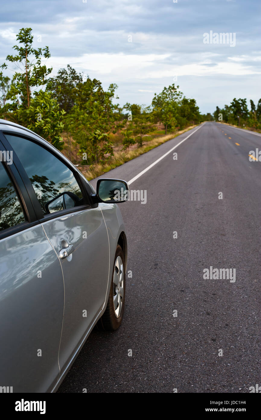Rear side perspective view of car on road countryside Stock Photo - Alamy