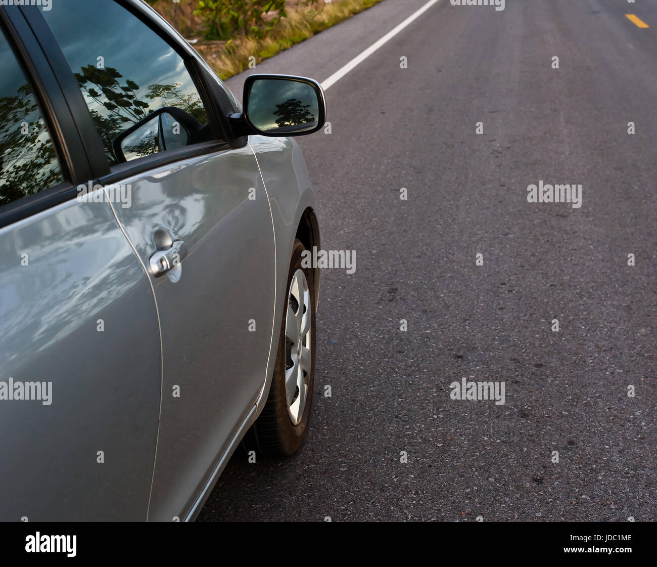 Rear side perspective view of car on road countryside Stock Photo - Alamy