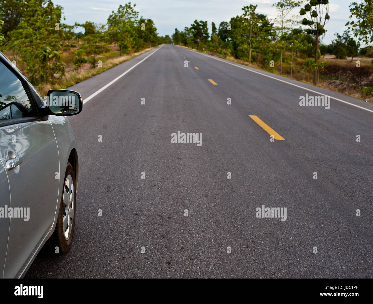 Rear side perspective view of car on road countryside Stock Photo - Alamy