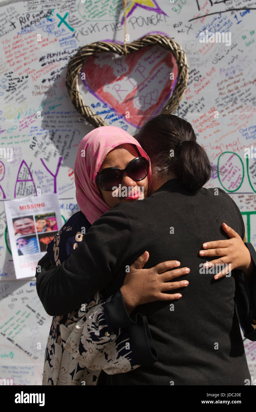People leave tributes on a wall off condolence to the victims who died ...