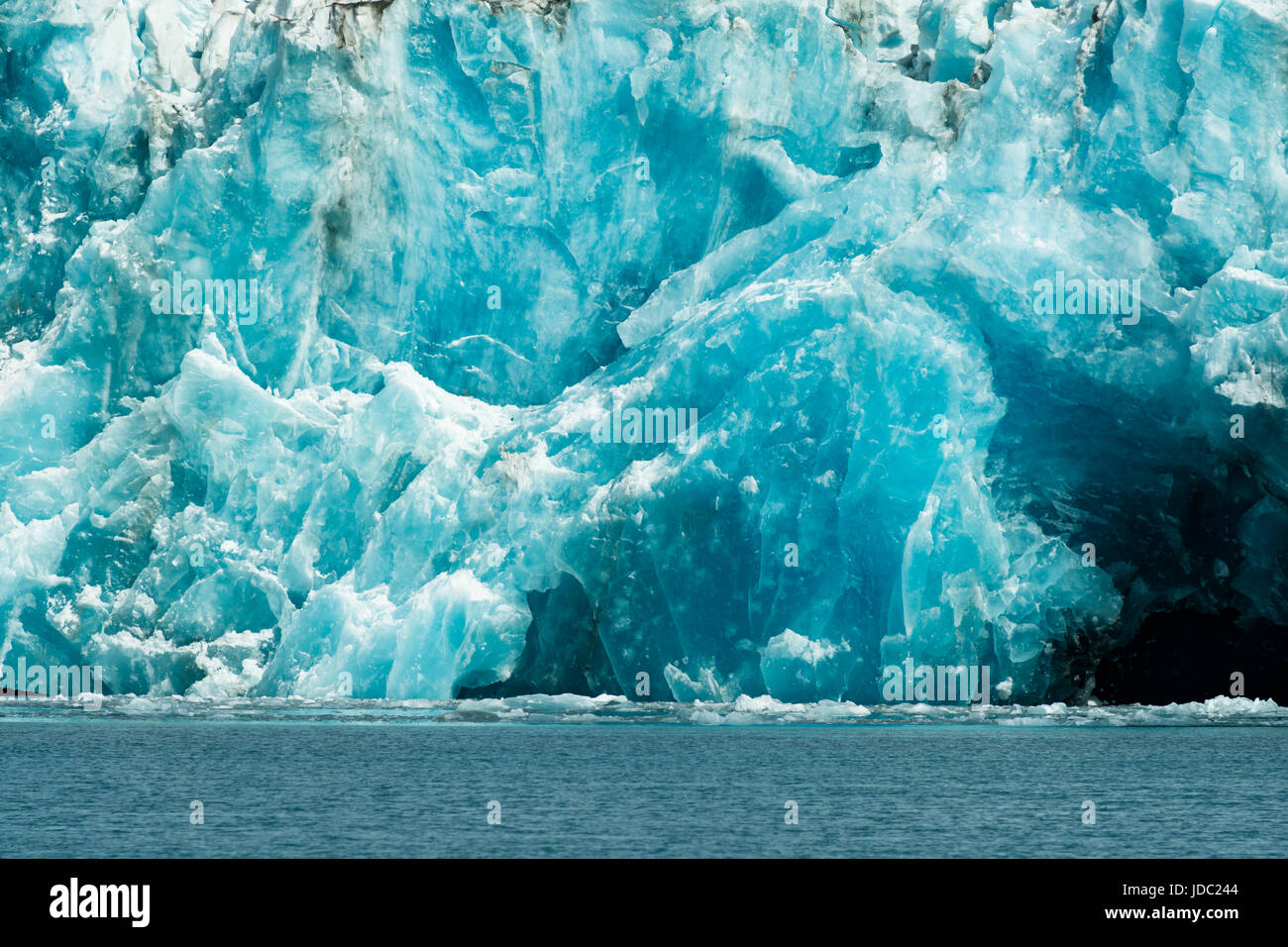 Glacier ice takes on a blue color in the sunshine Stock Photo - Alamy