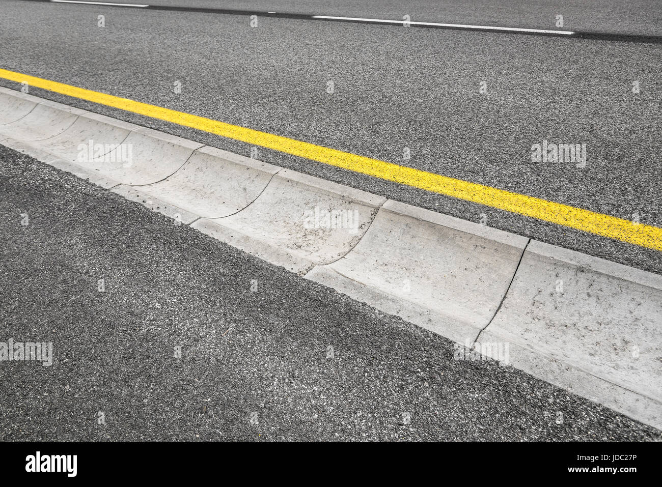 Drain concrete channel on the asphalt road Stock Photo - Alamy