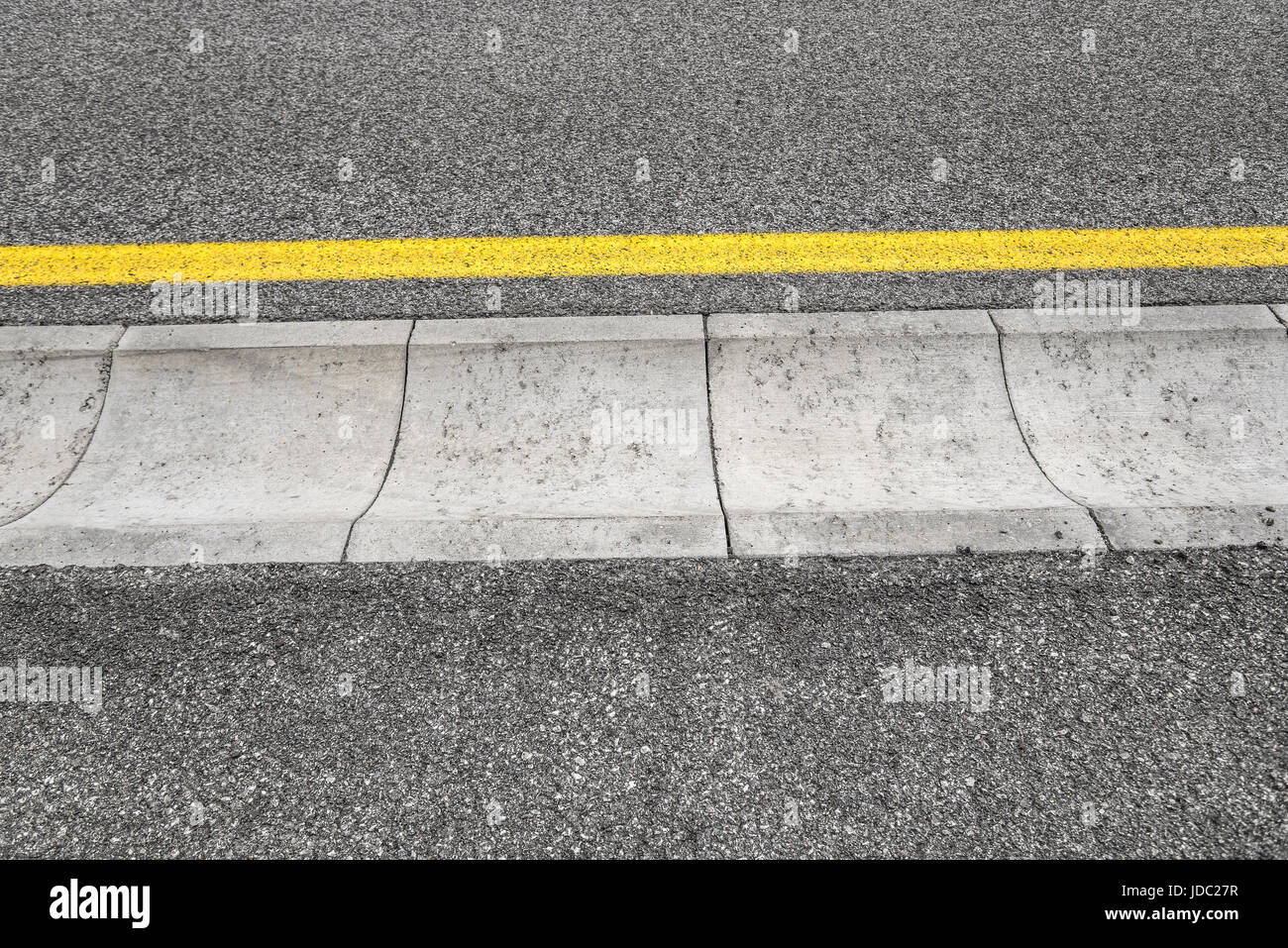 Drain concrete channel on the asphalt road Stock Photo - Alamy