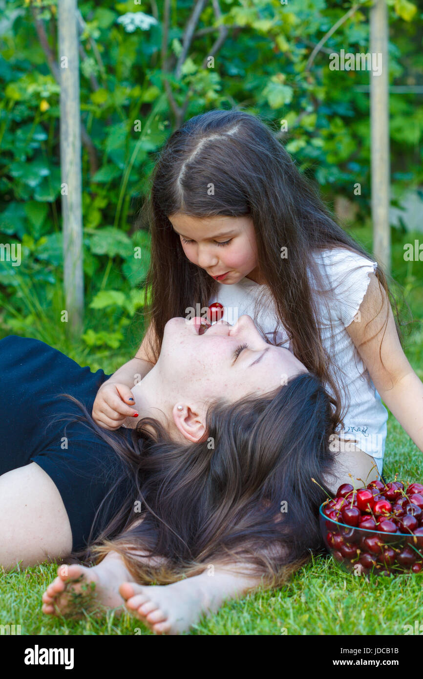 Child eating cherry hi-res stock photography and images - Alamy