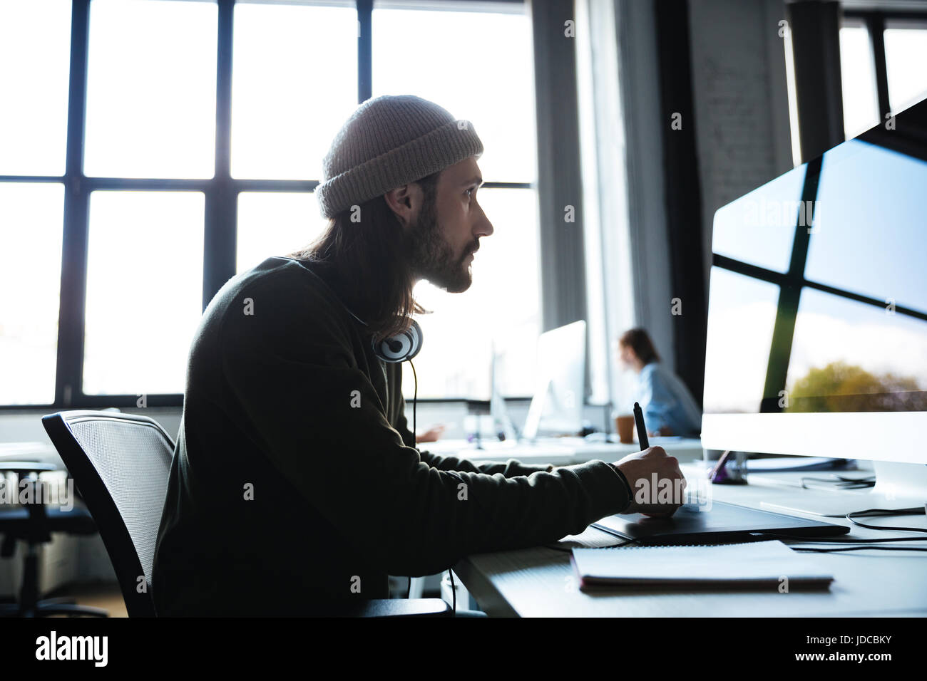 Image of young man work in office using computer. Looking aside Stock ...