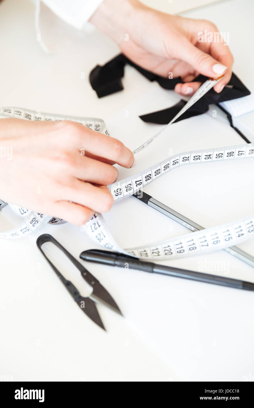 Close up of seamstress working with measuring tape in workshop Stock ...