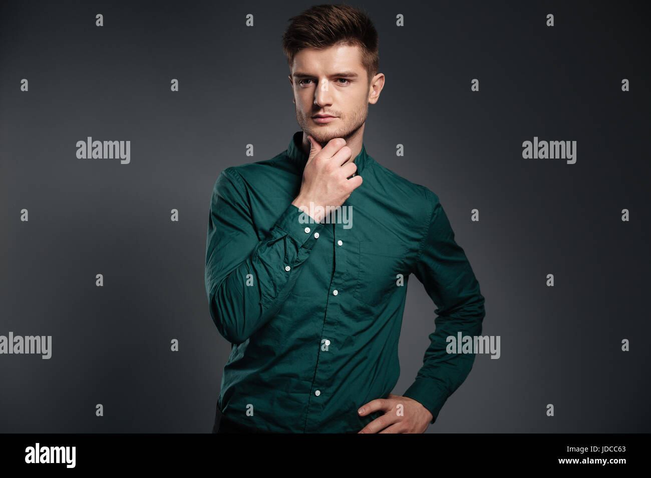 Image of handsome serious man dressed in shirt posing over grey ...
