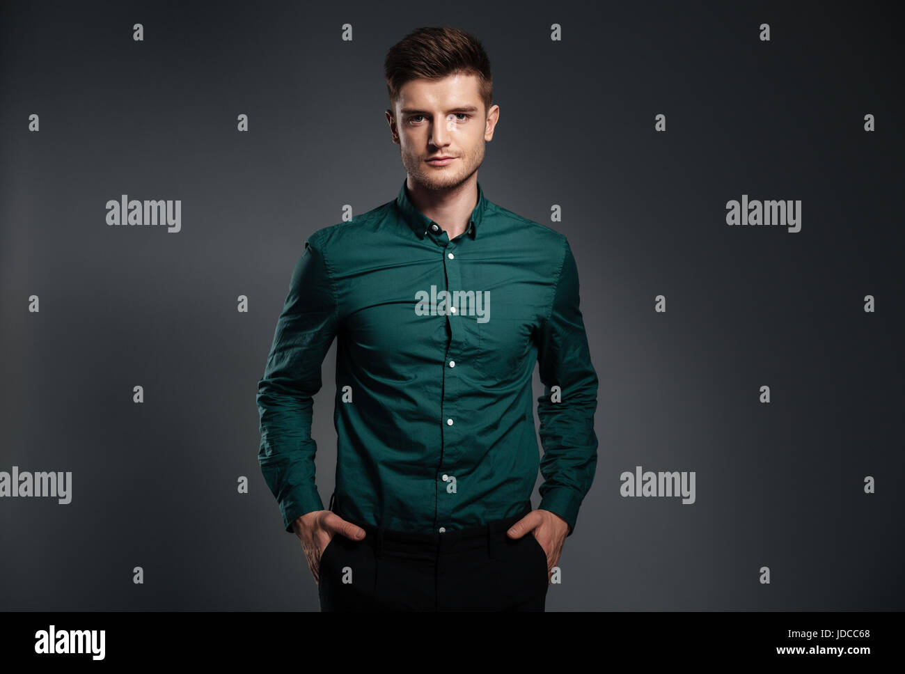 Image of handsome serious man dressed in shirt posing over grey ...