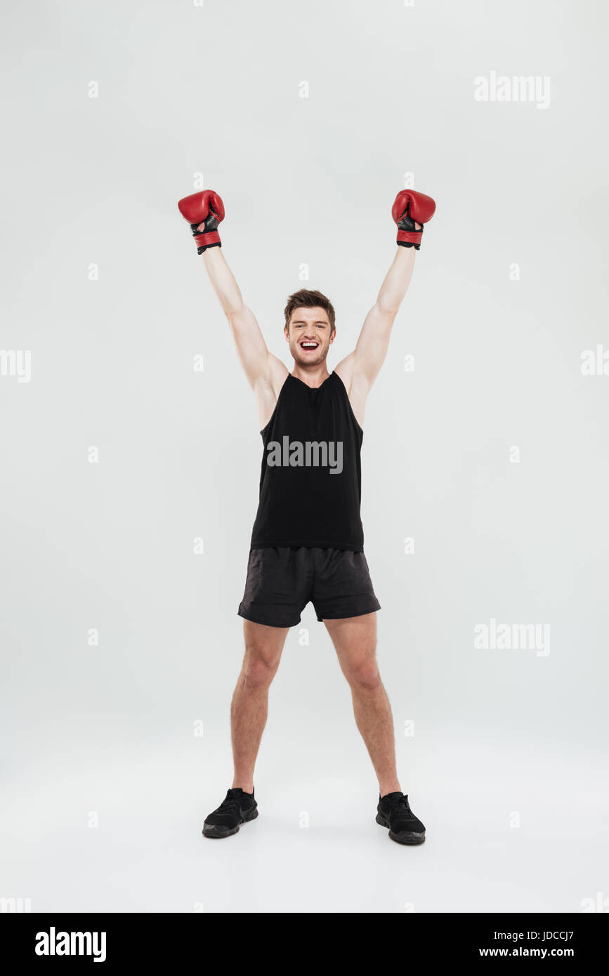 Image of happy screaming young sportsman boxer standing isolated over ...