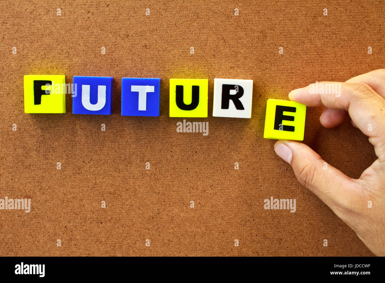 hand holding the word future isolated on wood board Stock Photo - Alamy