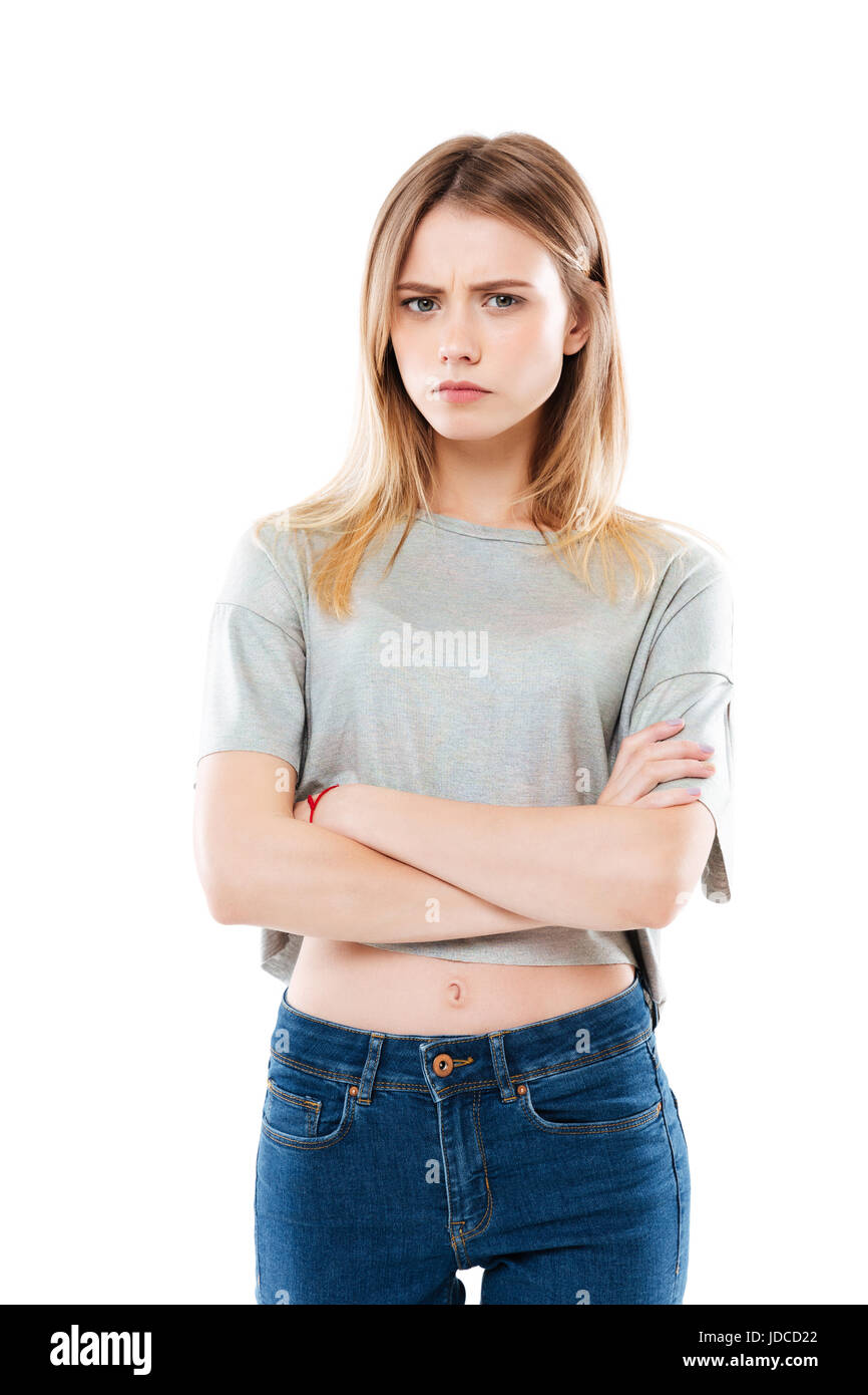 Portrait of an angry disappointed girl standing with arms folsed and ...