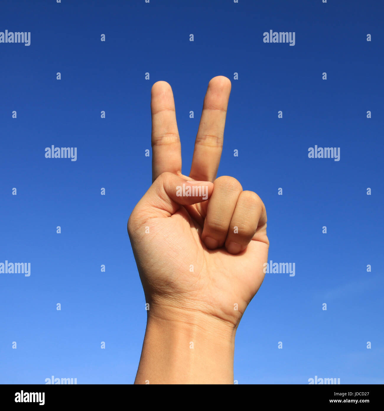 counting hand sign with blue sky Stock Photo - Alamy