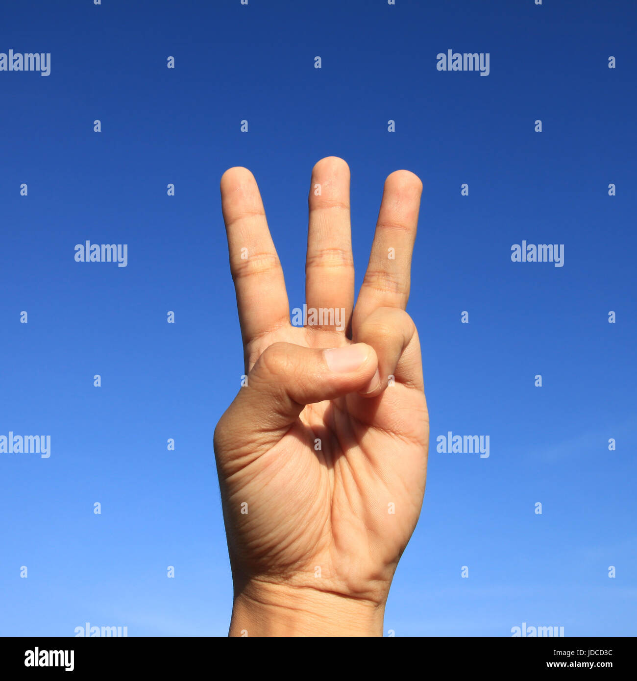 counting hand sign with blue sky Stock Photo - Alamy