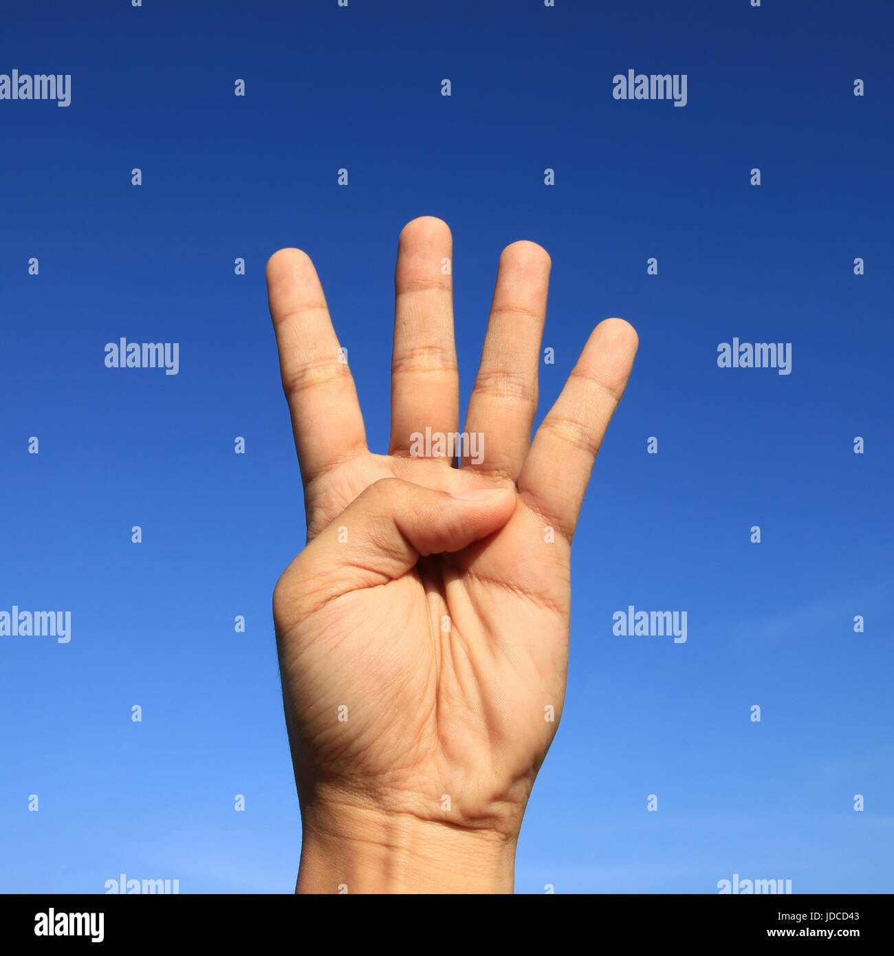 counting hand sign with blue sky Stock Photo - Alamy