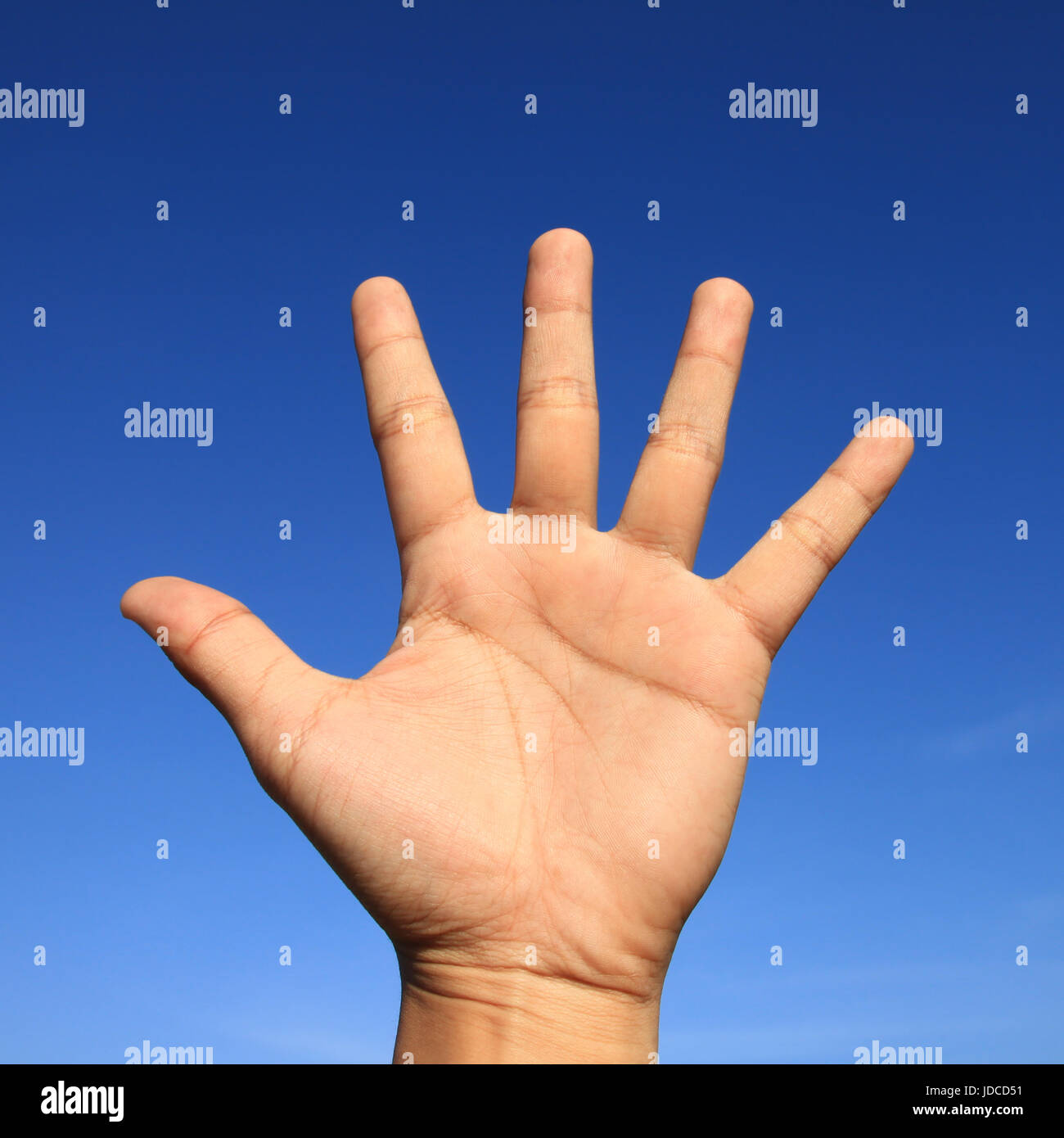 counting hand sign with blue sky Stock Photo - Alamy