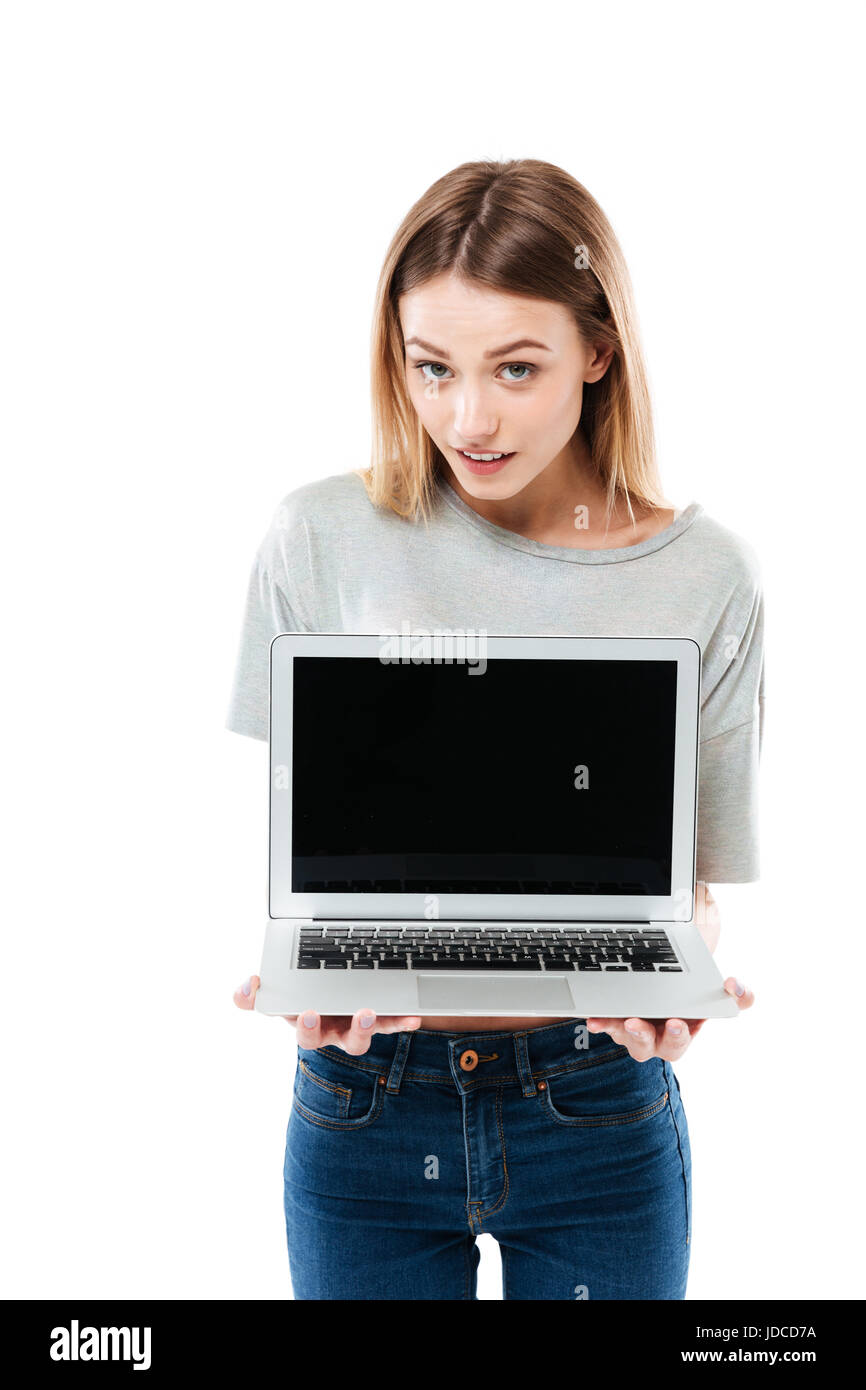 Young confident woman showing laptop computer with blank screen and ...