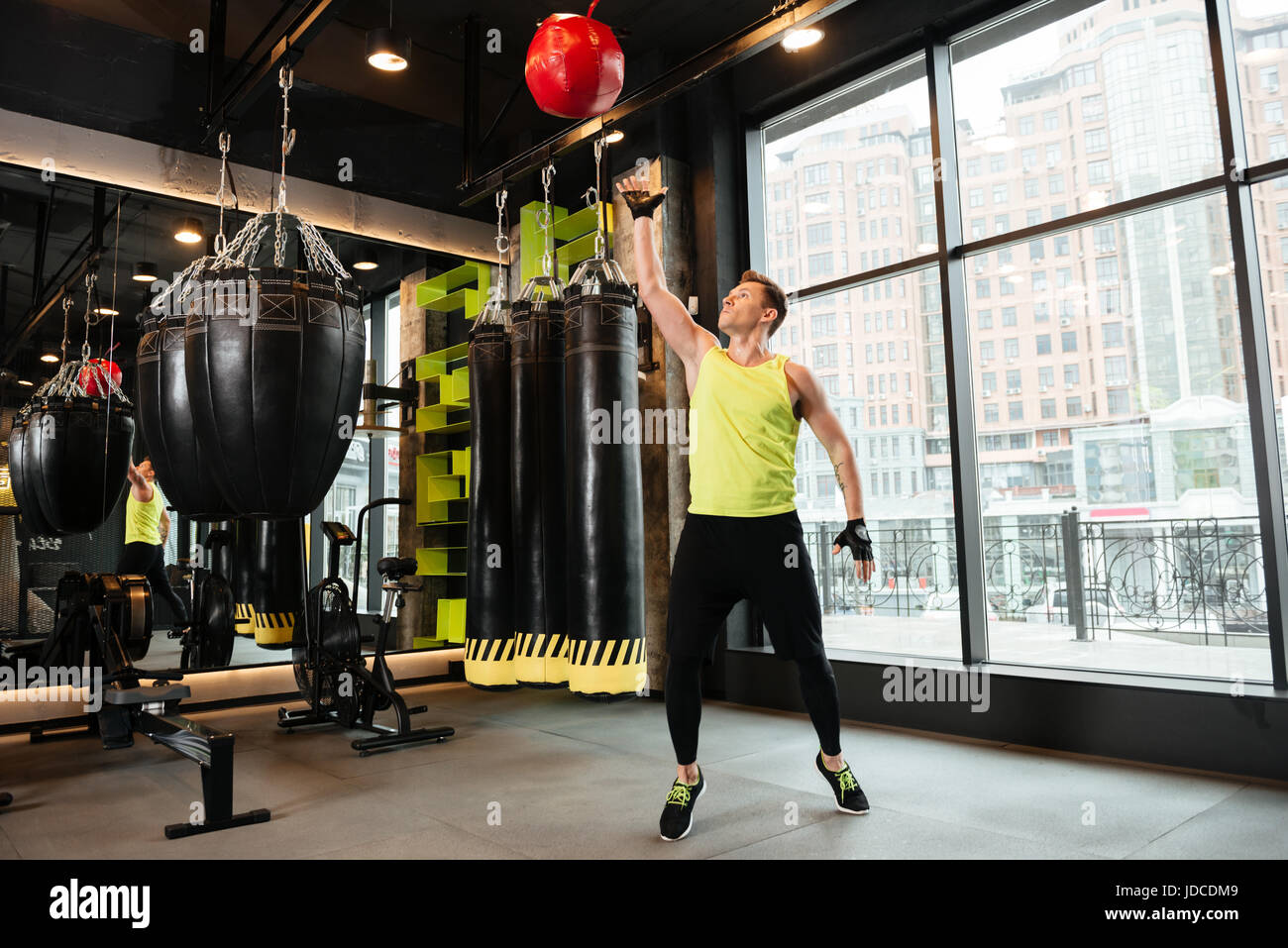 Young sportsman throwing weight ball while working out at the gym Stock ...