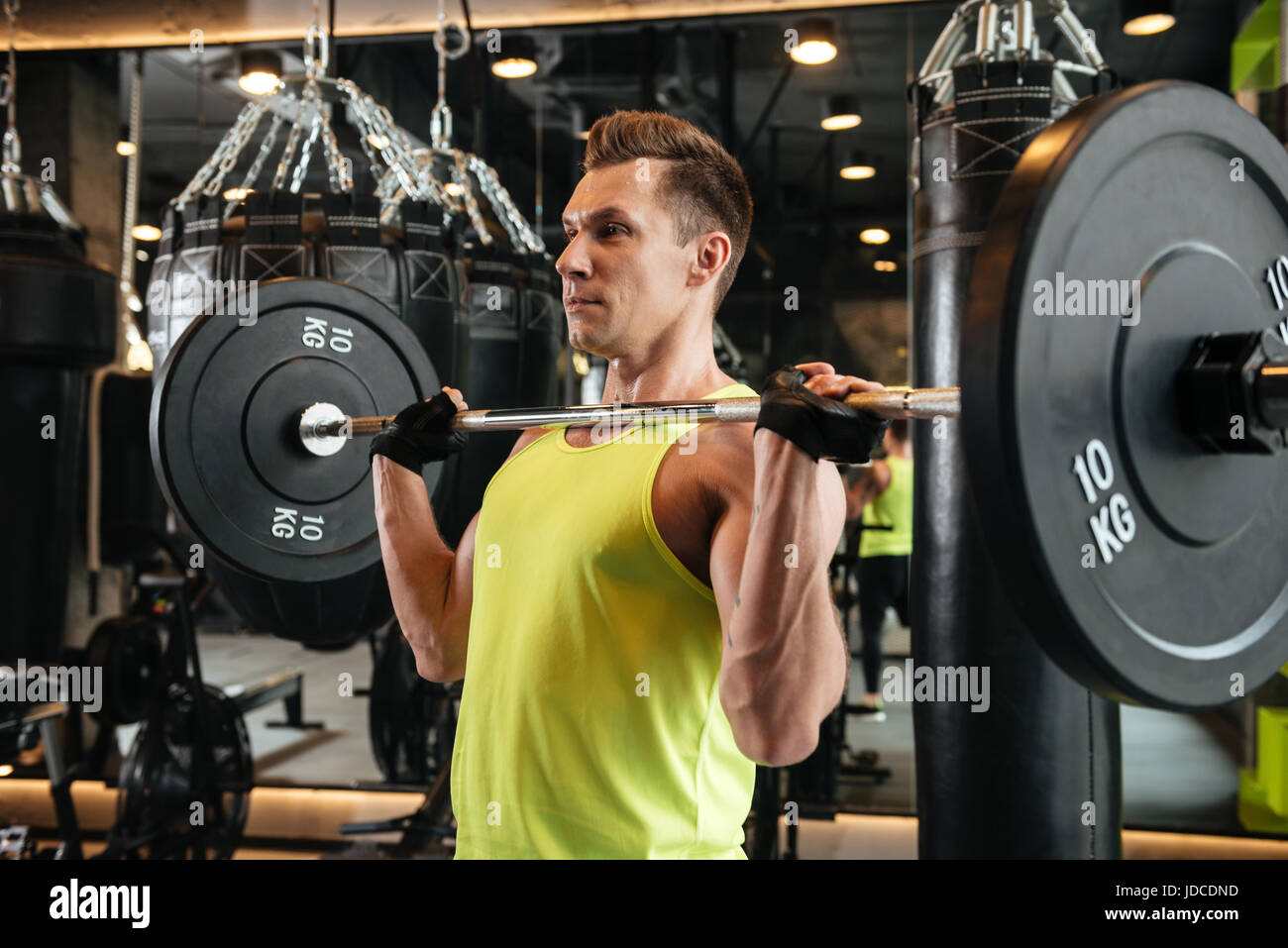 Muscular strong sportsman lifting hi-res stock photography and images ...