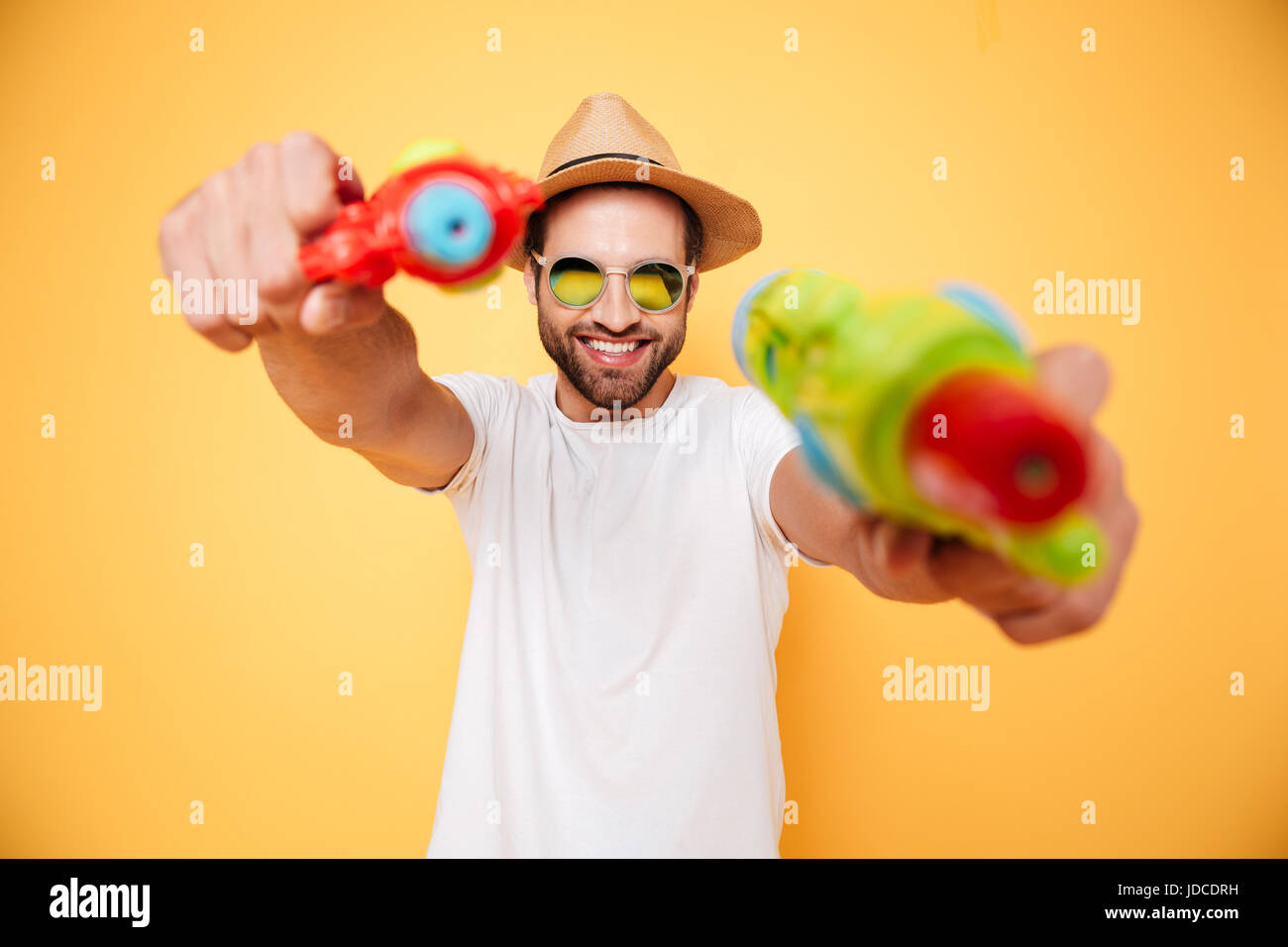 Image of happy young man standing isolated over yellow background ...