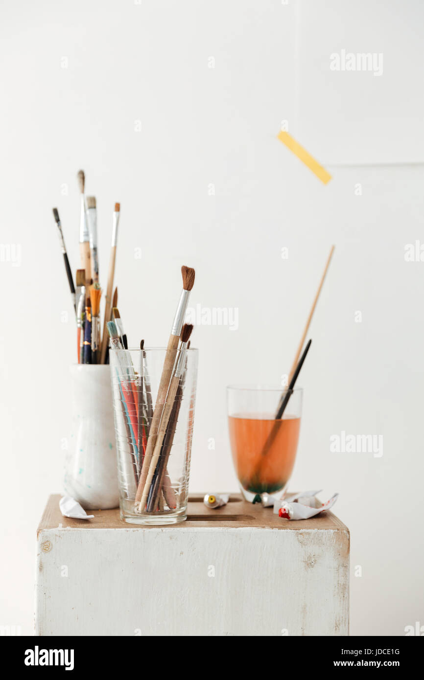 Image of painting brushes over white wall Stock Photo - Alamy