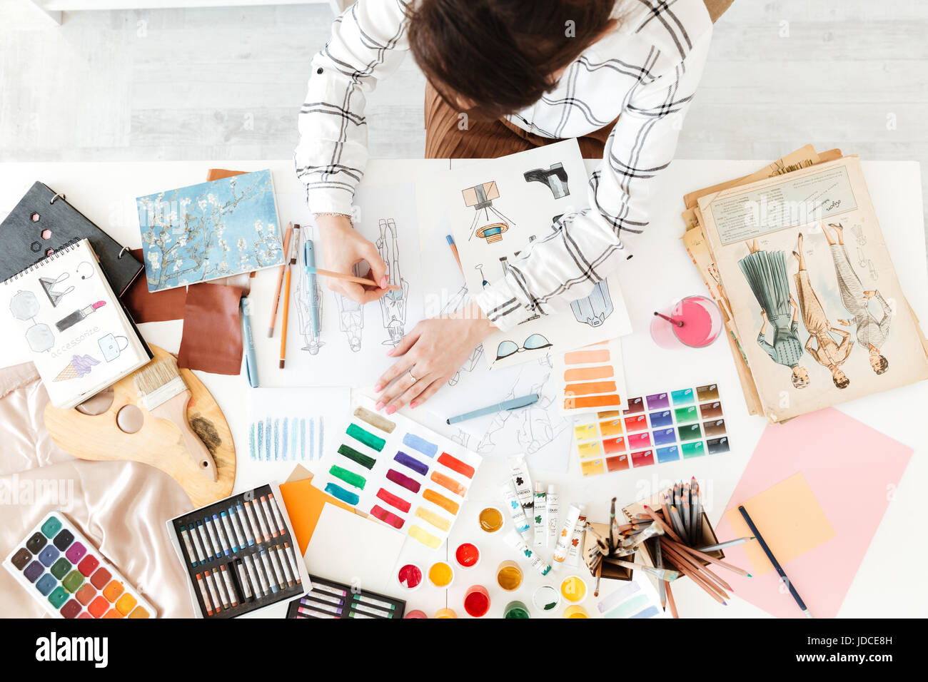 Top view cropped photo of young woman fashion illustrator sitting at ...