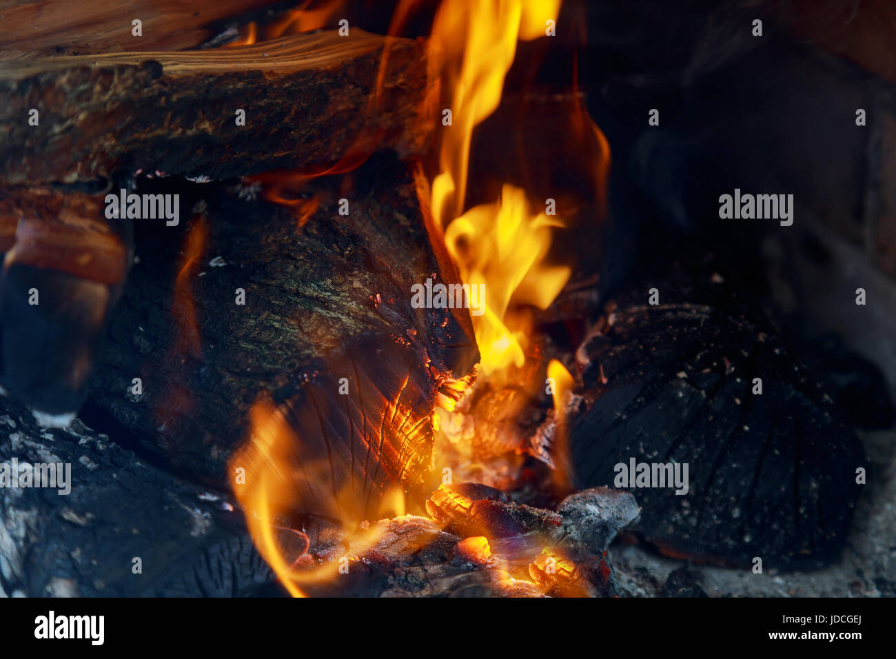 crest of flame on burning wood in fireplace Burning wood and coal Stock ...